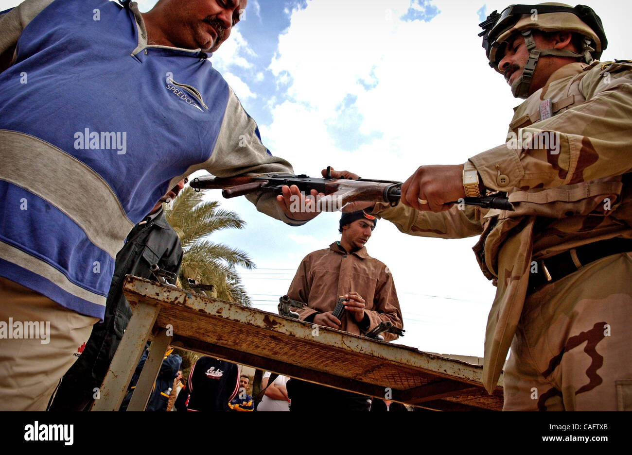 Feb 20, 2008 - Baghdad, Iraq - An instructor hands an AK-47 to a Sons ...