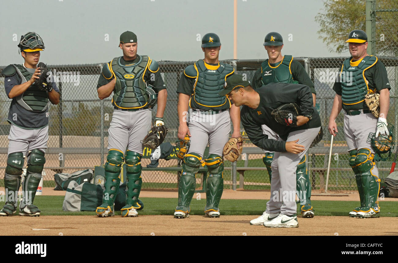 A's catchers work on throwing drills during Spring Training at Papago ...
