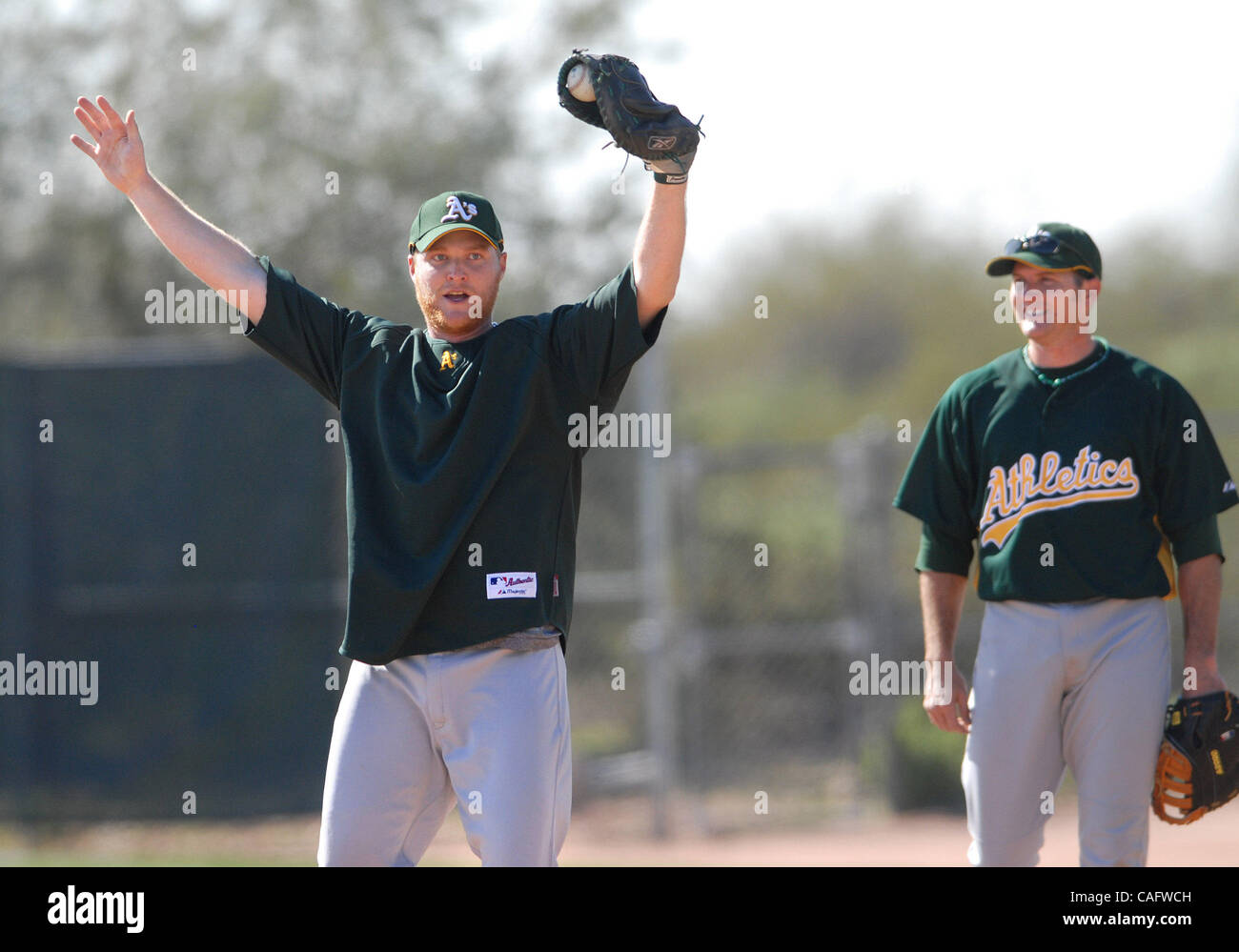 Oakland Athletics first baseman Dan Johnson, left, celebrates catching ...