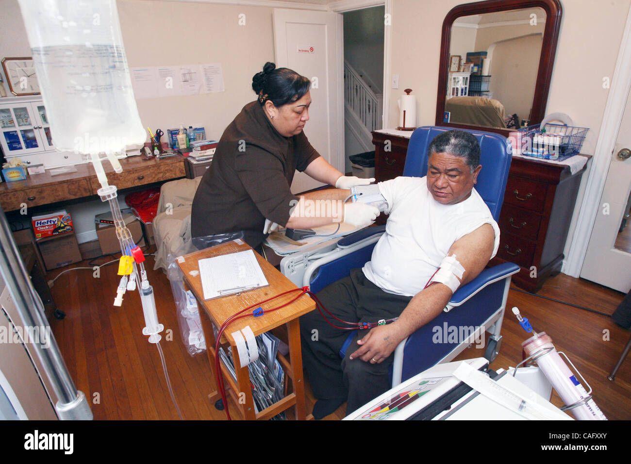 Soana Faasisila(left) helps her husband Saia hook up his portable ...