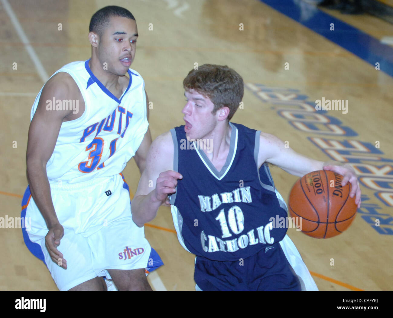 Mac Baker (#31) of St. Joseph Notre Dame guards (#10) Brett Schroeder ...