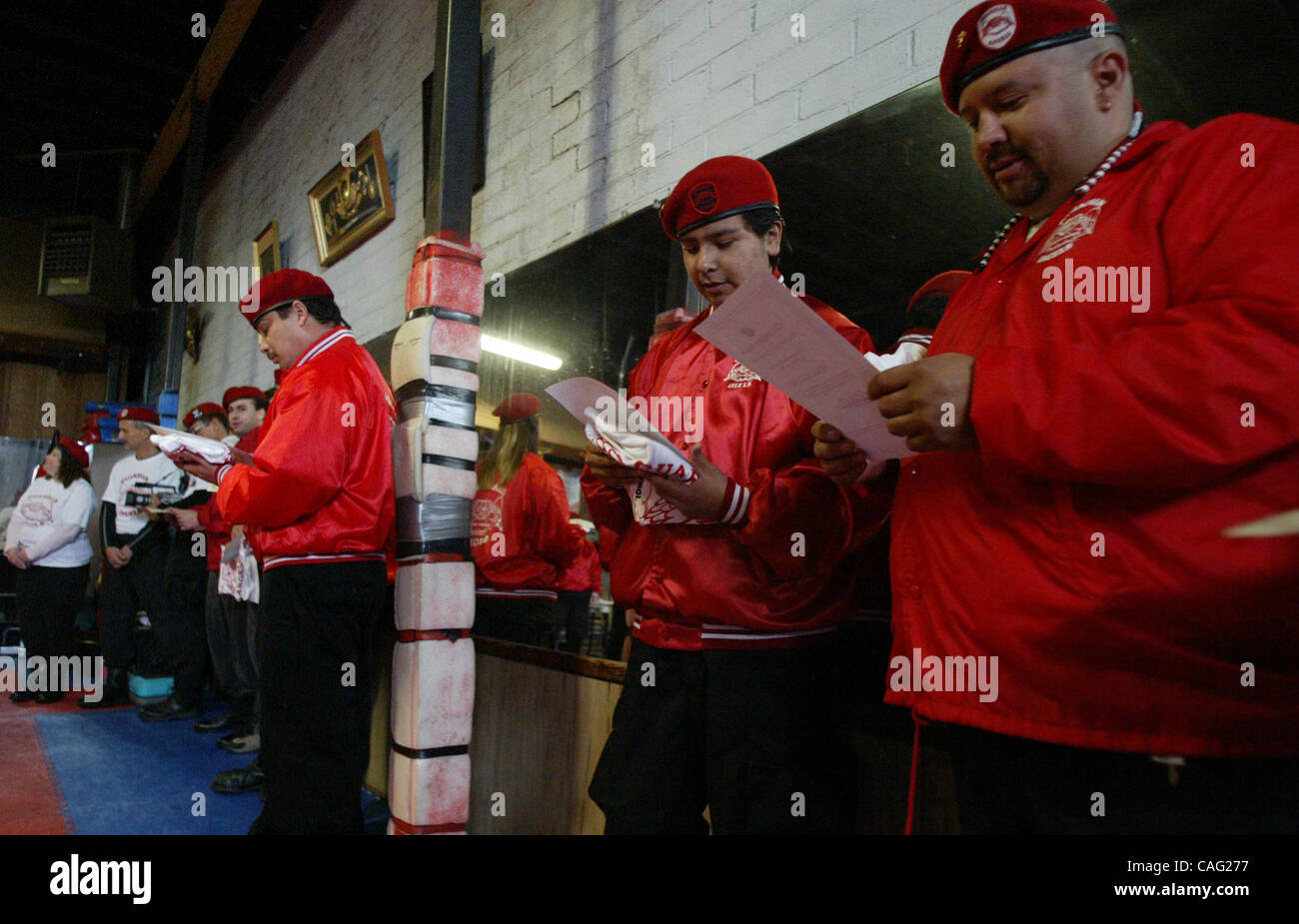 Newly-inducted Guardian Angels examine their certificates at Oakland's ...