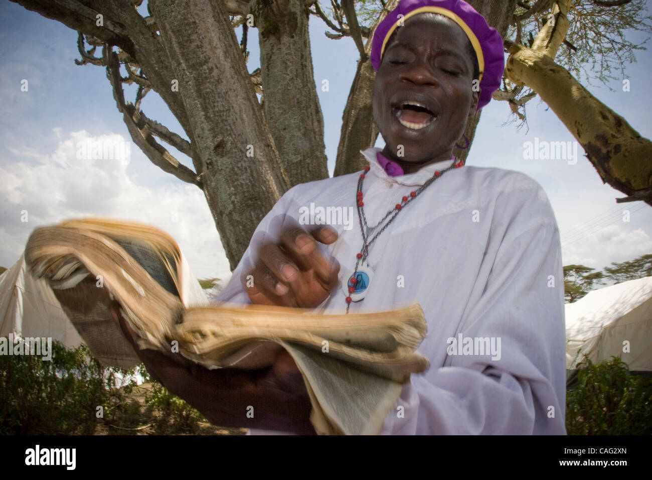 Pastor George Odhiambo, who is among the displaced, holds a Sunday ...
