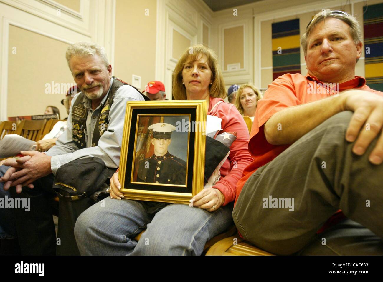 Deborah Johns of Roseville, center, holds a portrait of her son Sgt ...