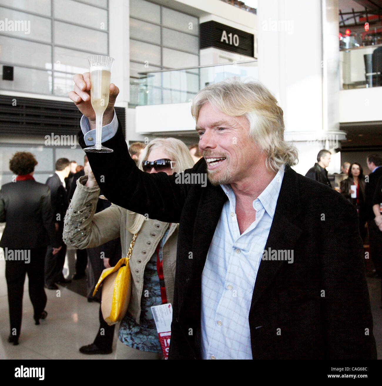 Virgin Airlines founder Sir Richard Branson raises his glass to toast ...