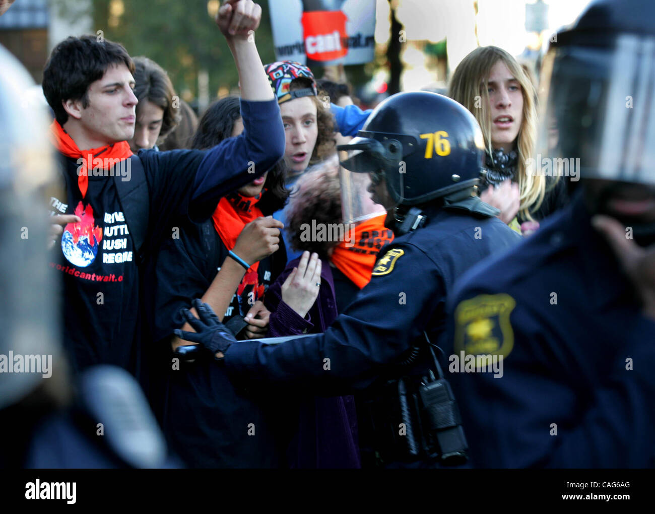 War protestors yell at the pro war protestors through the line of cops ...