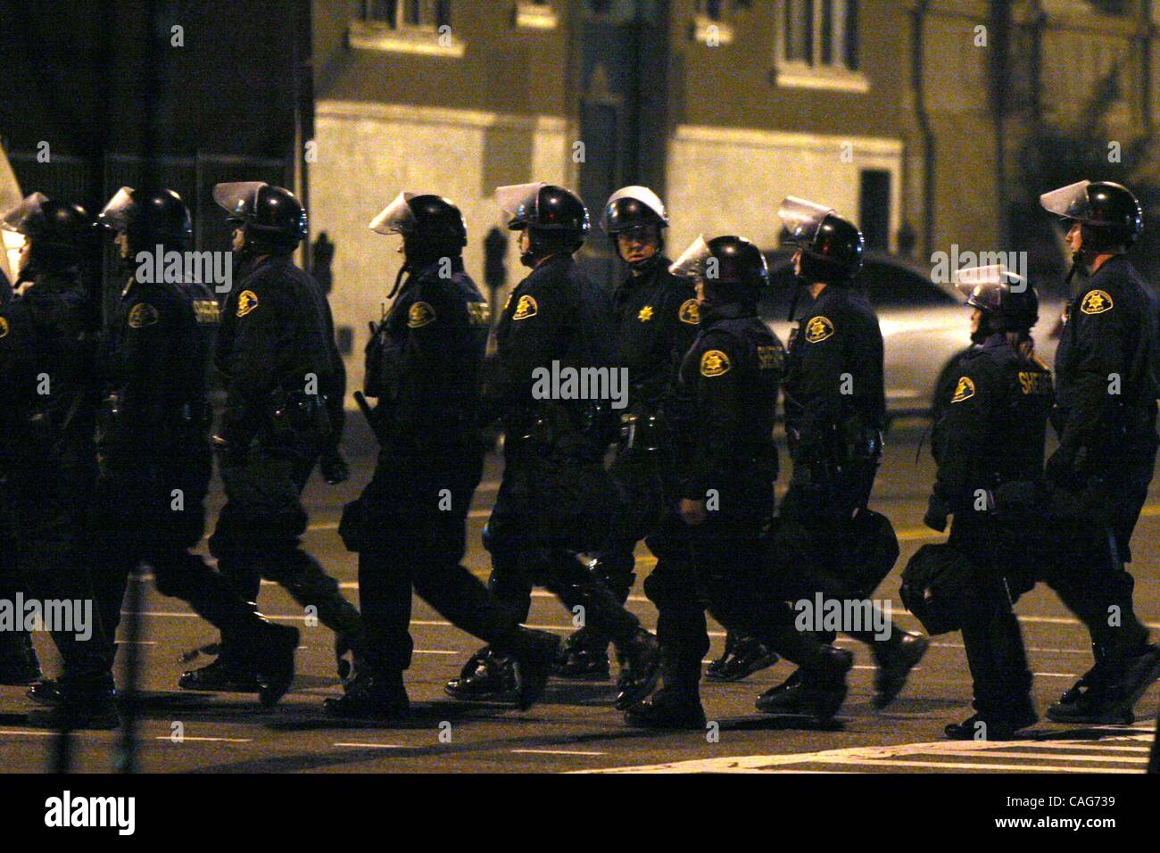 Some of the Berkeley Police officers in riot gear walk away after ...