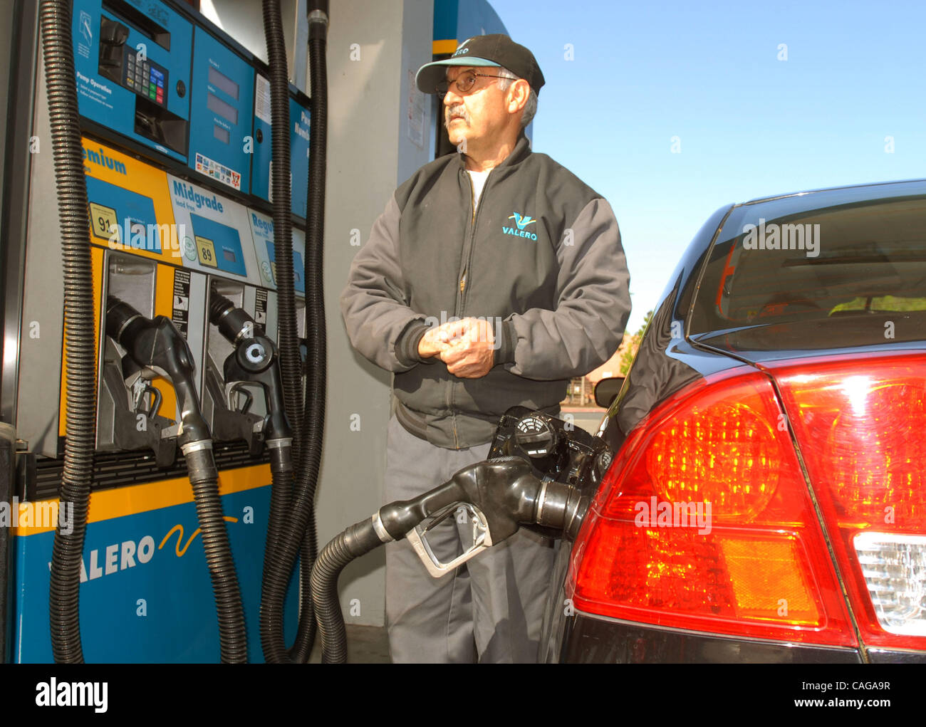 Valero station owner Gus Shahadi pumps gas for a full service customer ...
