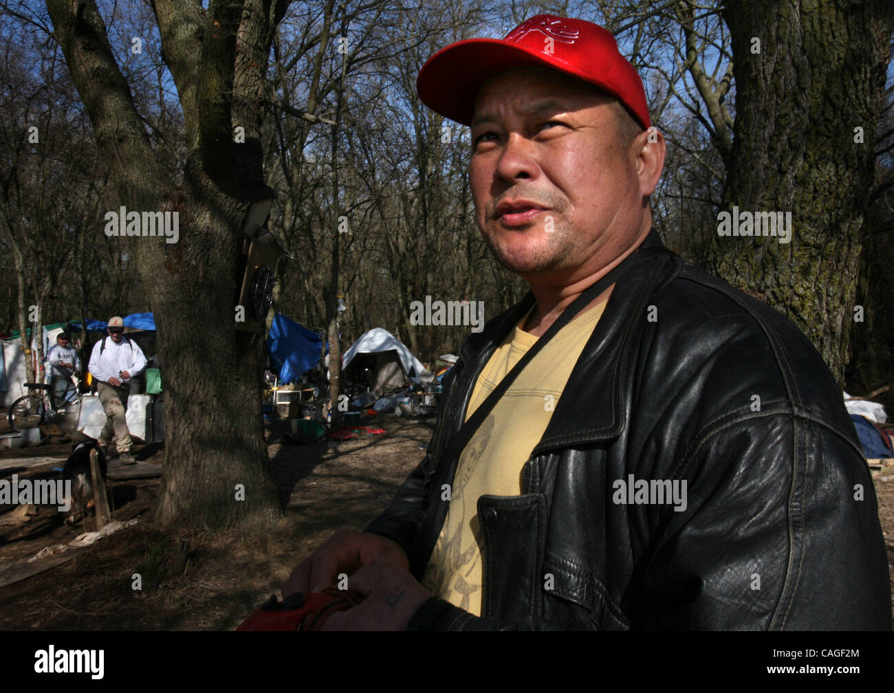 Patrick Toves looks out over the Sacramento River with a homeless camp ...