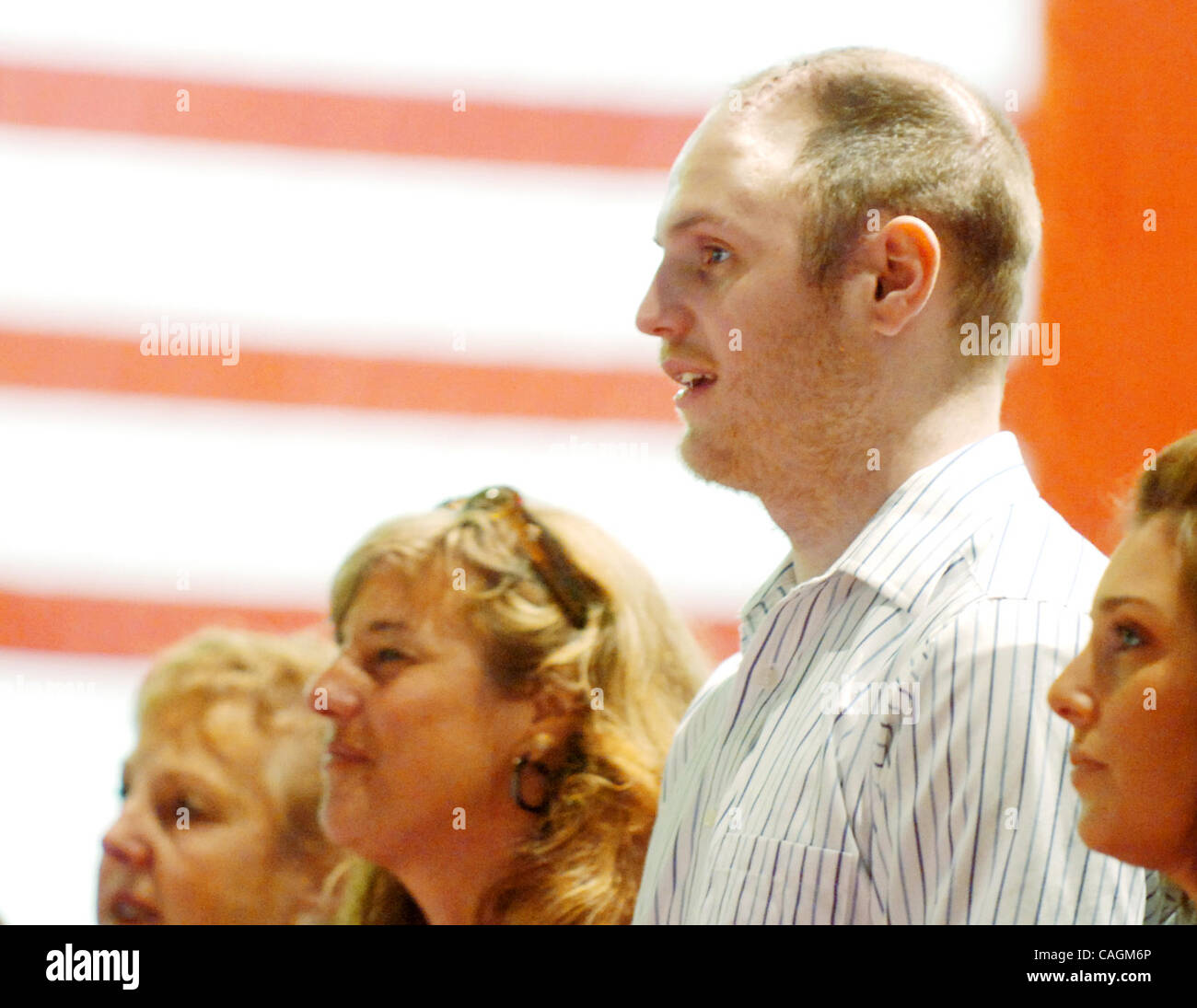 Wounded Navy medic Chris Braley stands to sing "My Country Tis' Of Thee ...