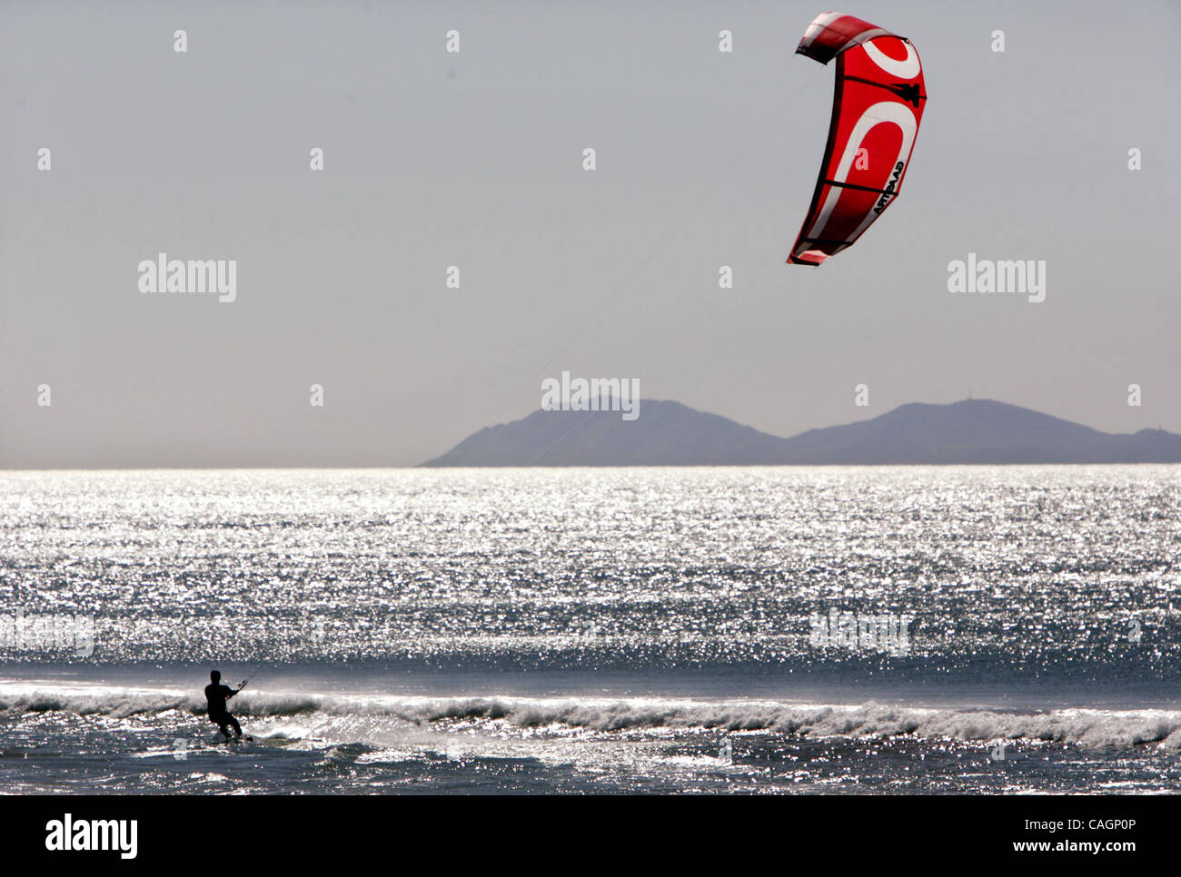 A kite surfer takes to the ocean off of Silver Strand State Park ...