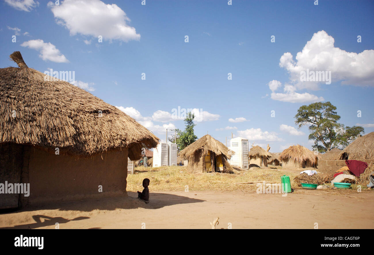 A child seeking shade under a hut at this Internally Displaced People ...