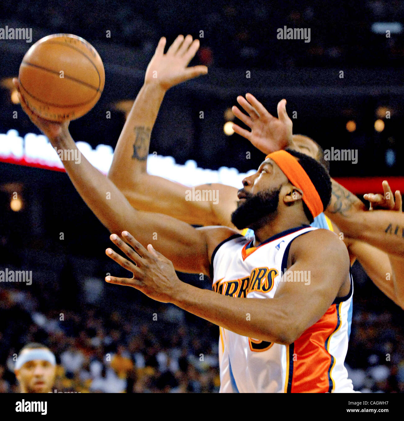 Golden State Warrior Baron Davis goes up surrounded by arm's trying to ...