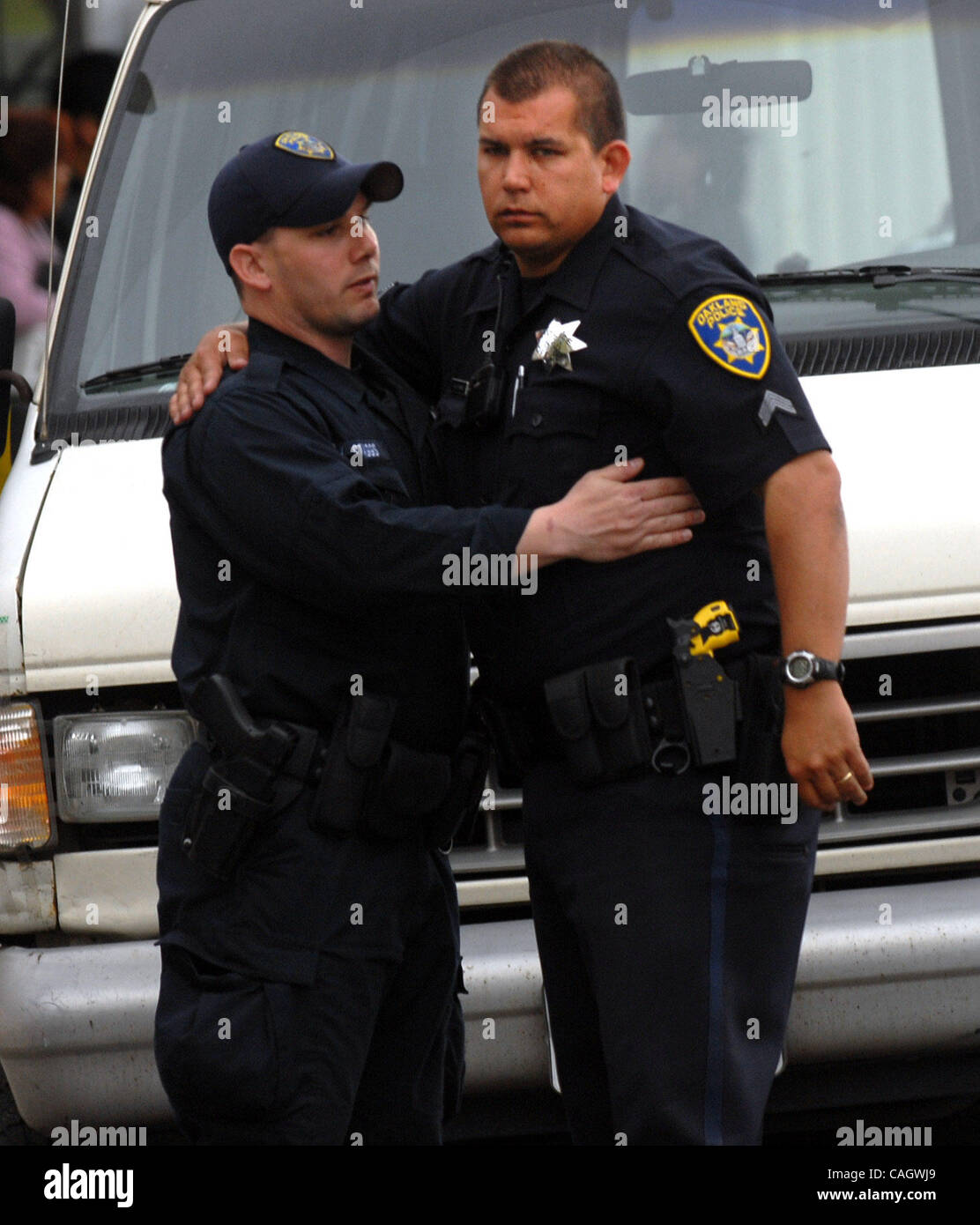 Two Police officers embrace each other after hearing of fellow police ...