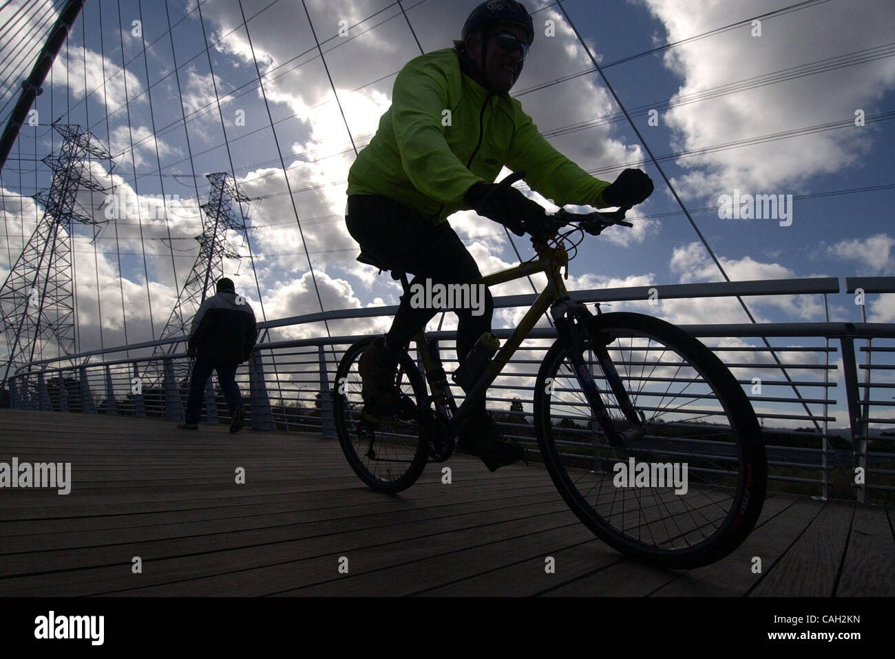 A cyclist rides by Ryder Park along the SF Bay in San Mateo, Calif ...