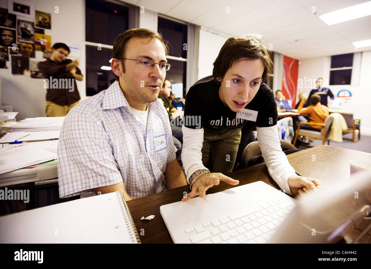 Maggie Fleming, 28, right, works with Adam Langton, 29, on the Barack ...
