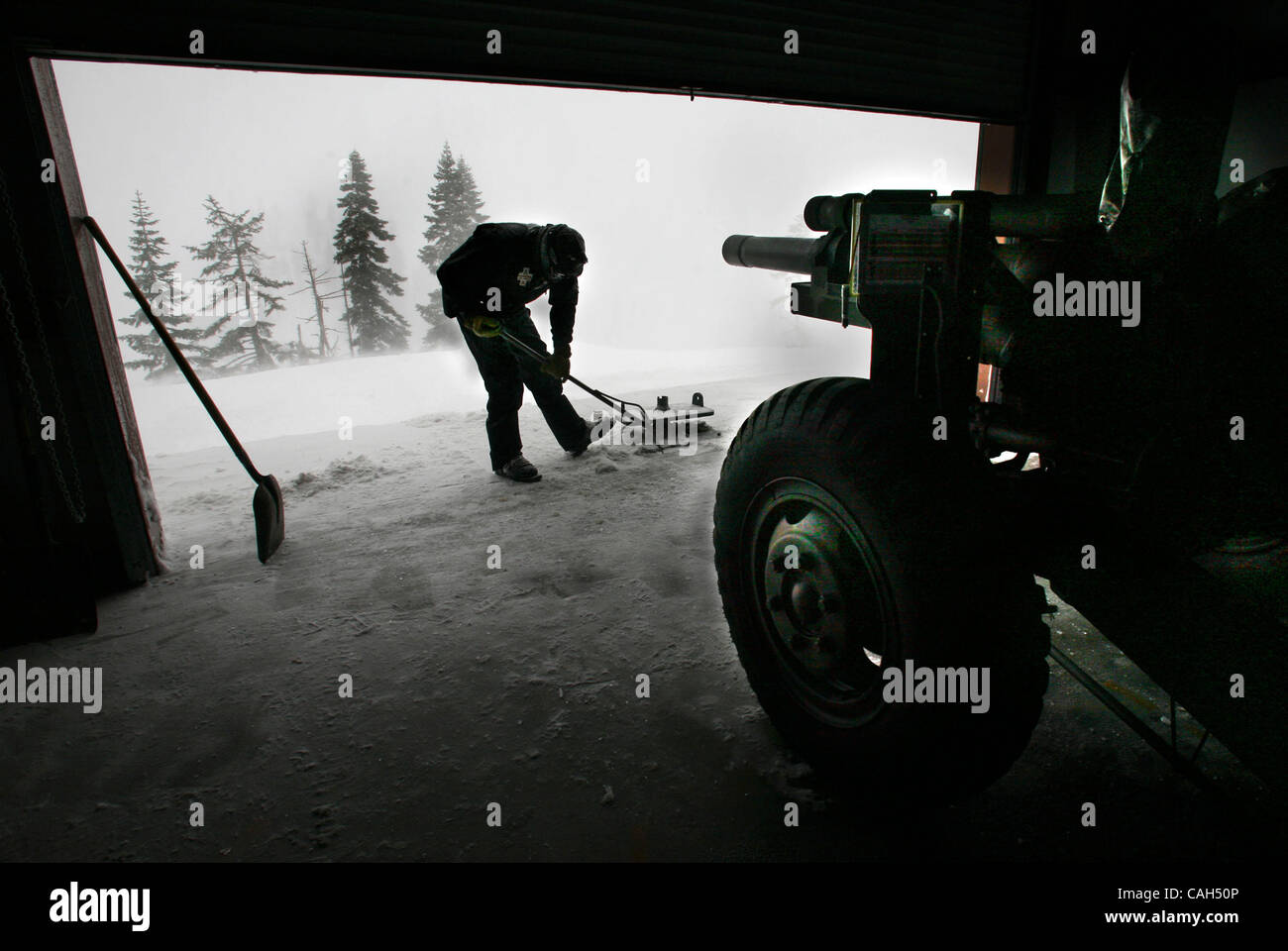 Shane Best an assistant gunner for the World War II Howitzer shovels ...