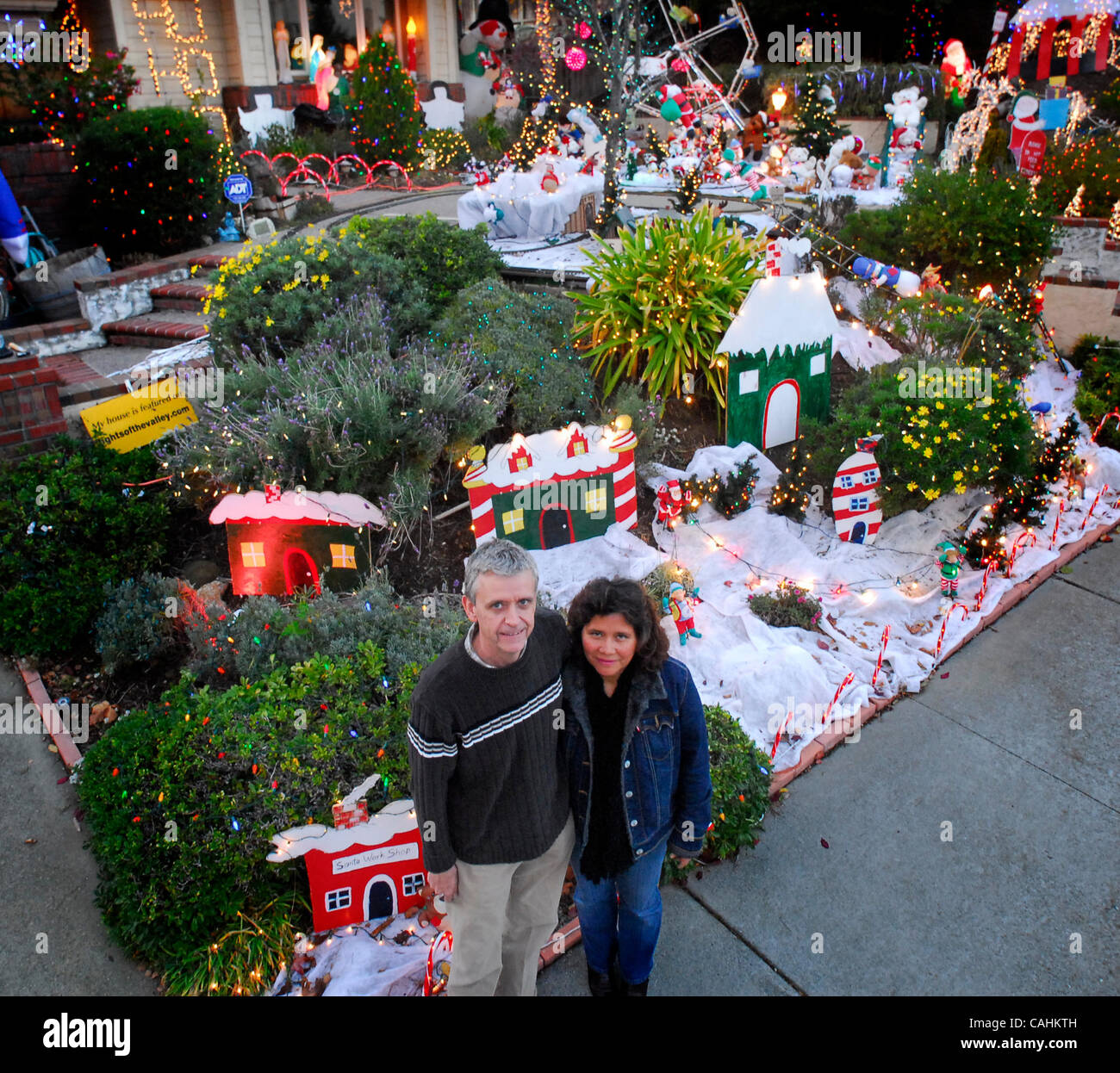 Simon Puttick and his Yanira stand in front of their holiday display at ...