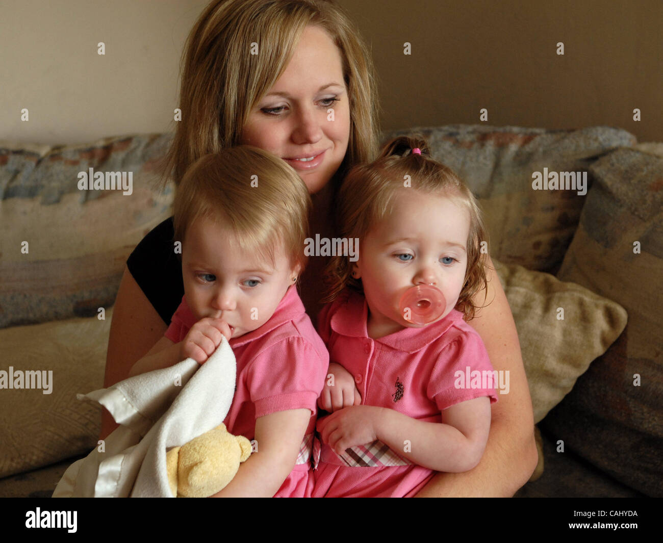 Natalie Allen has her hands full as holds her daughters Katelynn, left ...