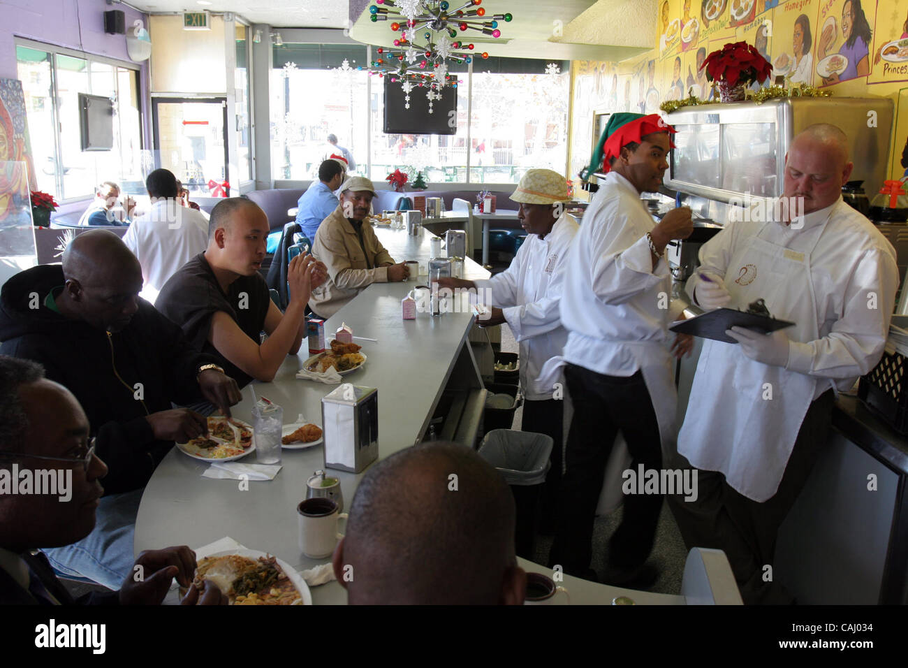 Derreck Johnson, second from right, oversees the serving of hundreds of ...