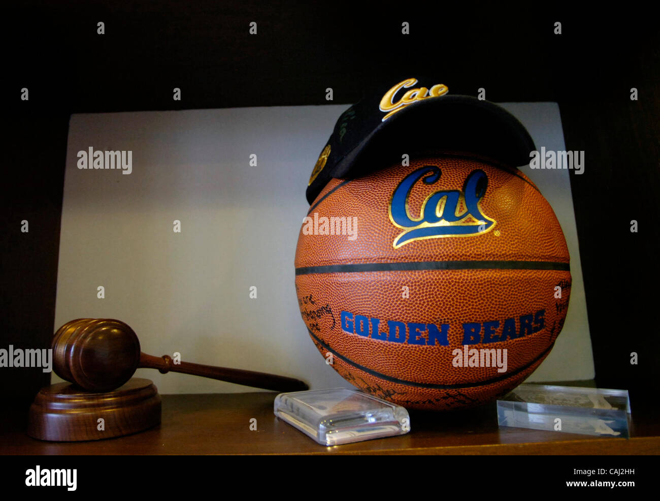JUMP SECOND -- A Cal basketball sits next to a gavel on a bookshelf ...