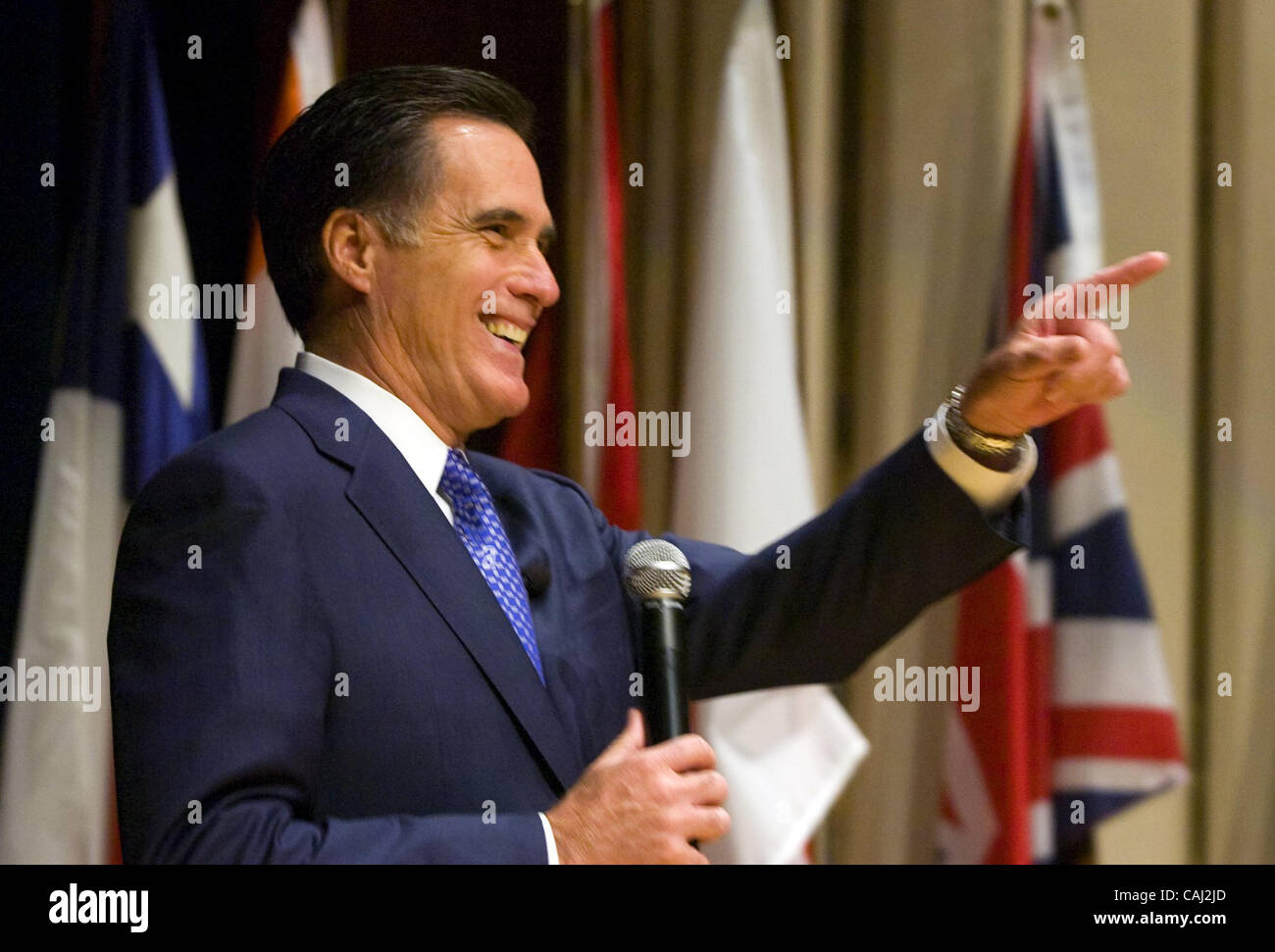 Republican presidential hopeful Mitt Romney talks to employees of ...