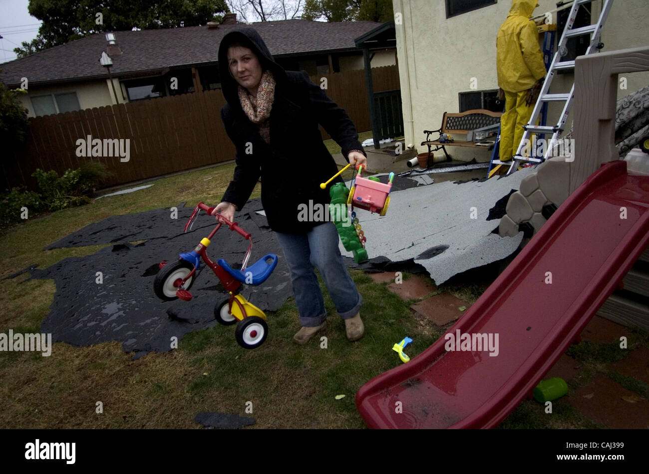Kasey Bierwirth, carries toys of her son Tony Bierwirth, 2, to a garage ...