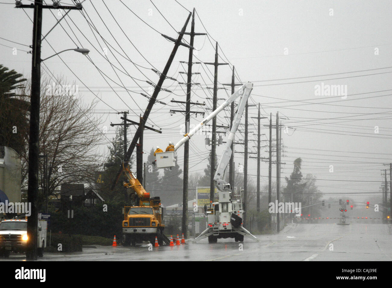 A SMUD truck supports a broken power pole which supports a 115,000-volt ...