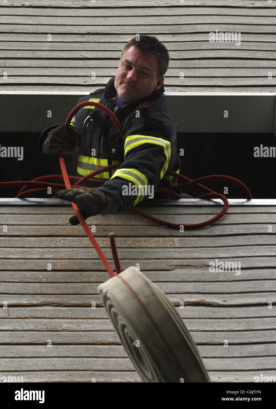 Folsom Fire Department Captain Clint Madden (cq) hoists a 45-pound hose ...