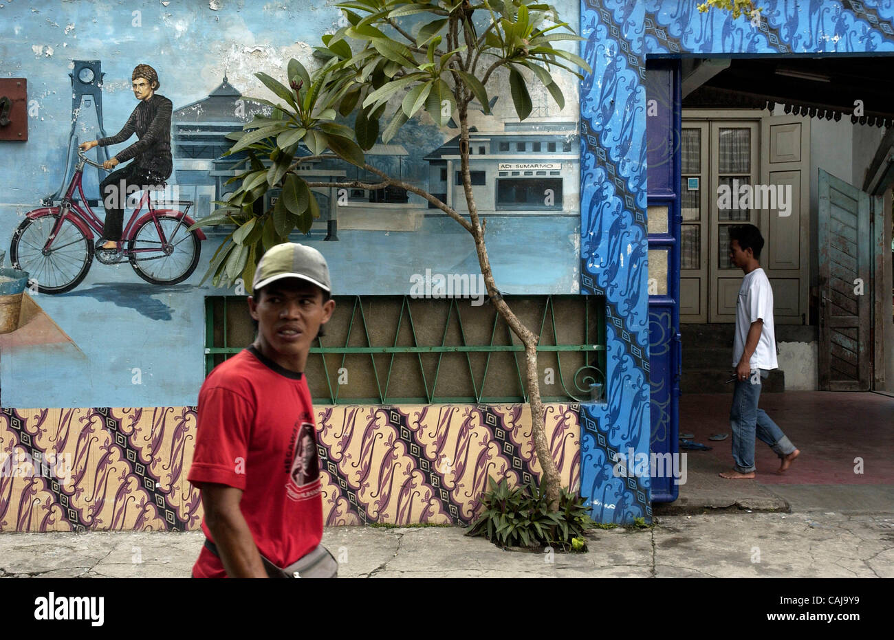 SOLO, CENTRAL JAVA, INDONESIA-JANUARY 13, 2008 An Indonesian man walks ...
