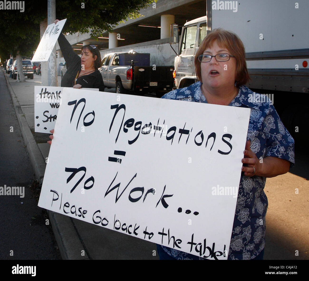 {L-R) Tammy Yazgulian and Barbara Keys holds signs in front of hte ...