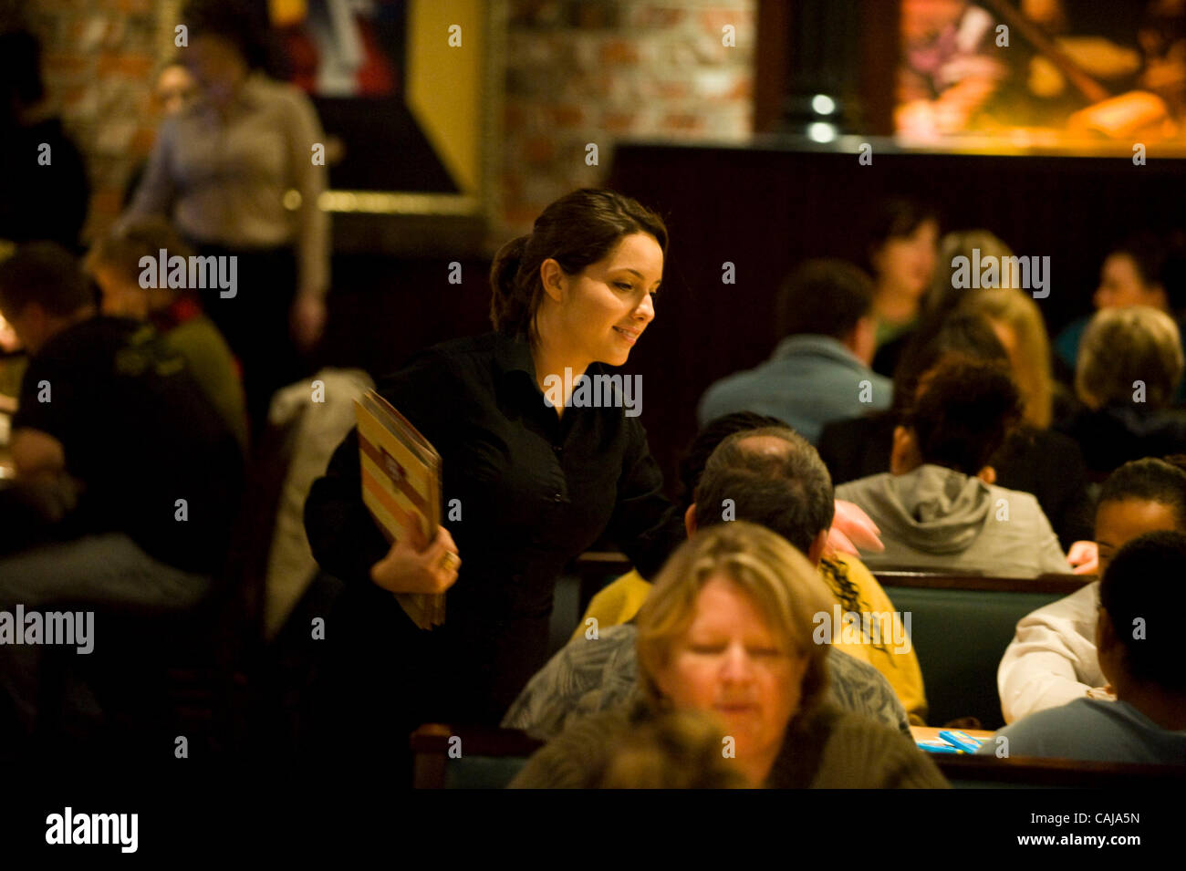 Sarah Carrillo (cq-age 20) passes out menu's after seating a family at ...