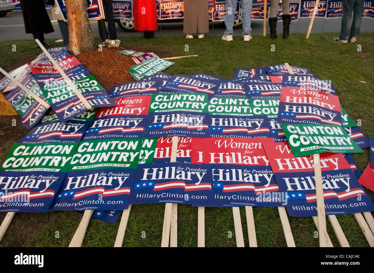 Campaign signs for Senator Hillary Clinton sit behind her supporters ...