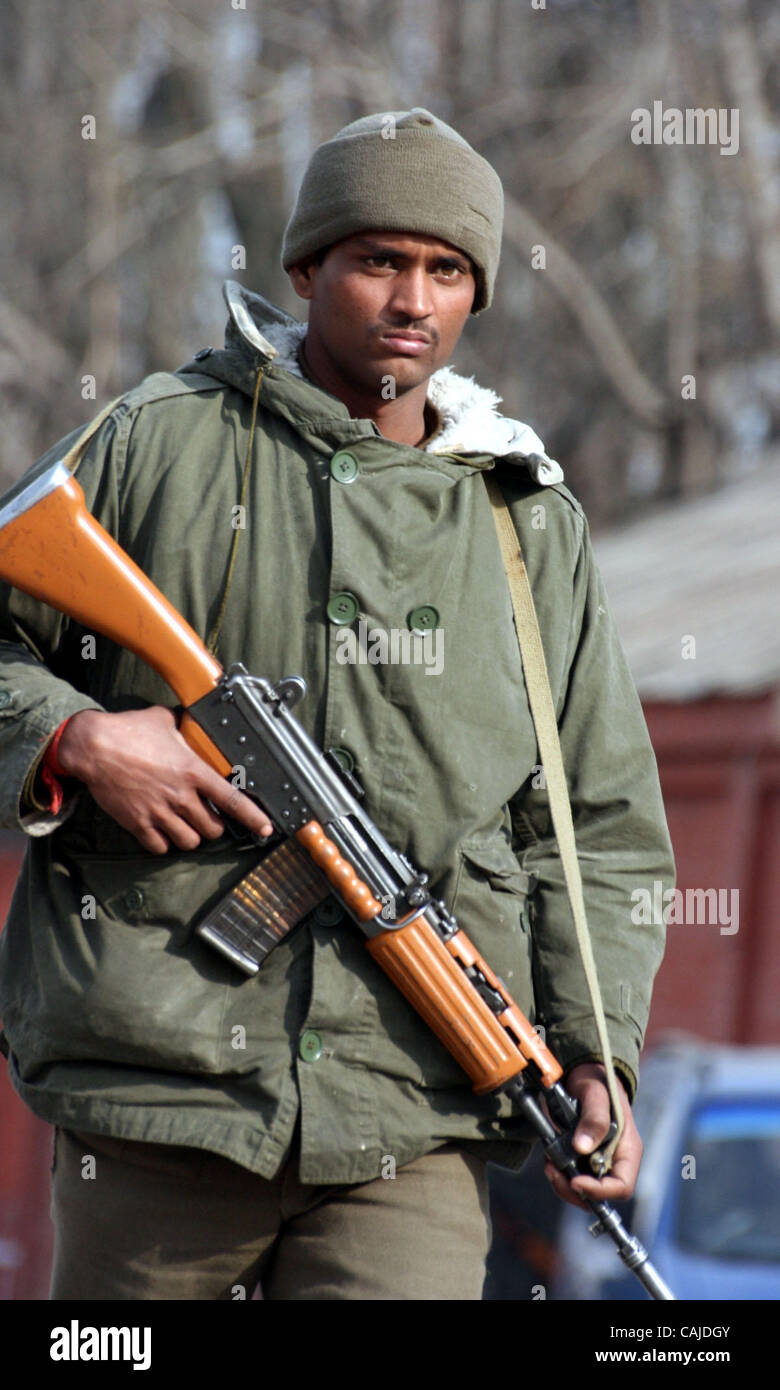 An Indian paramilitary soldier stands guard during cordon and search ...