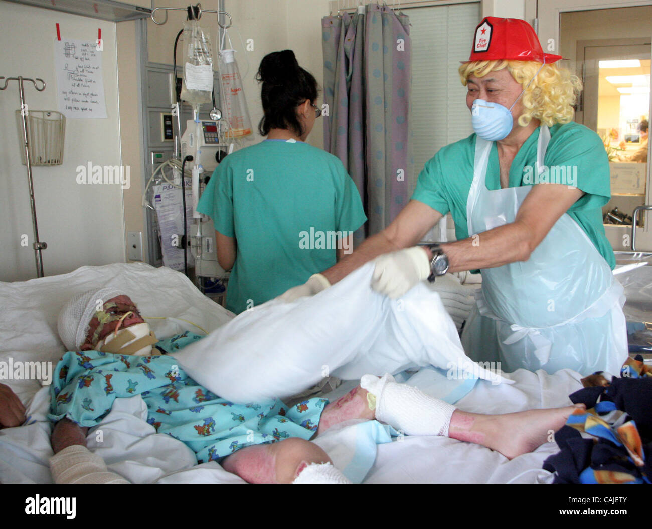 Burn technician "Cookie" Kimura (right) plays with Julian Zaragoza in ...
