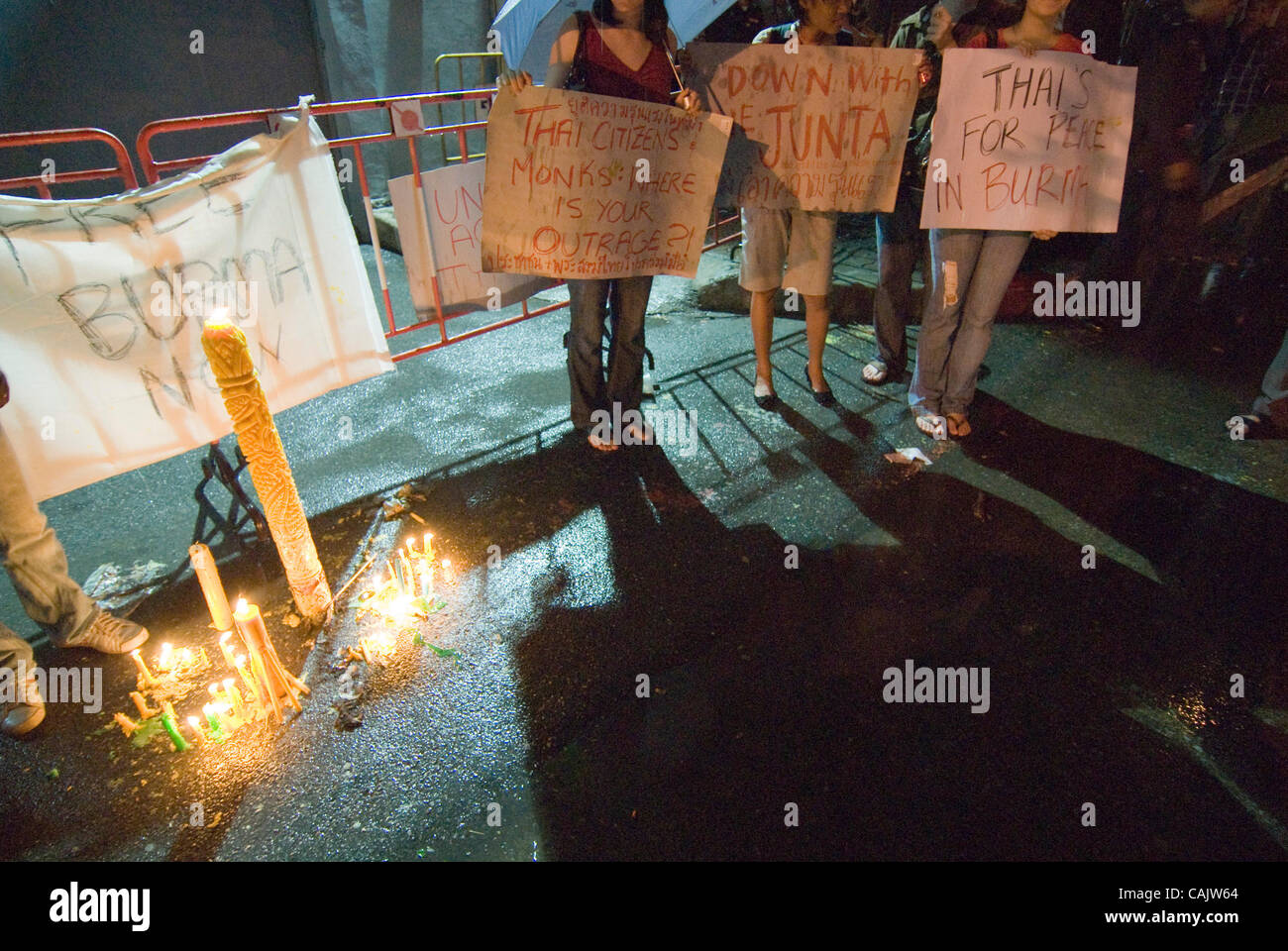 Thai activists take part in a candle light vigil in protest against the ...