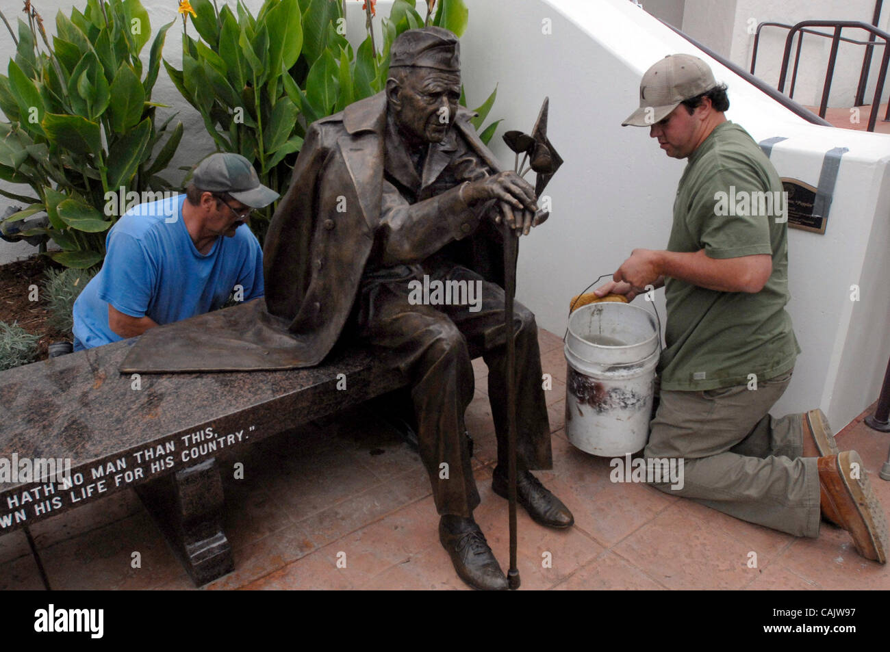 Bras & Mattos Monument Co. employees Chuck Ray of Hayward (left) and ...