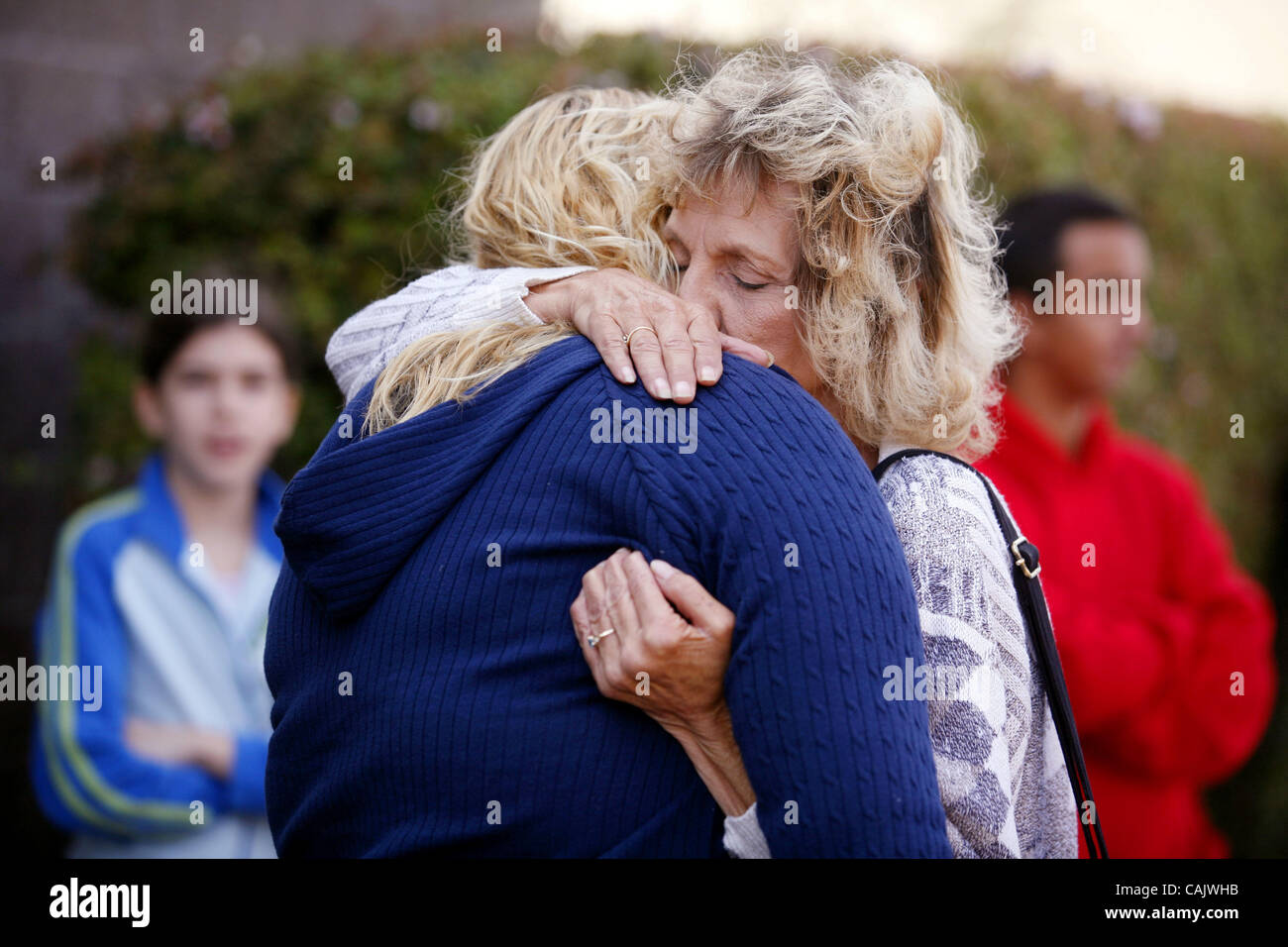 Heidi Patterson, left and family friend Sharon Babb, hug as they wait ...