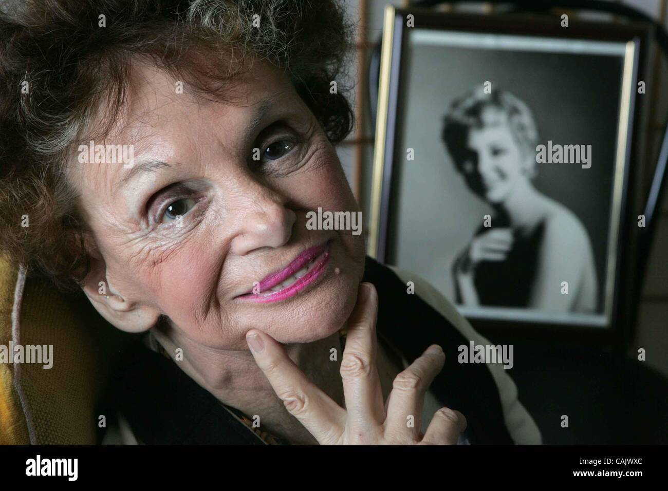 Elaine Dundy, 80, poses with an old photo of herself in the 1950s, at ...
