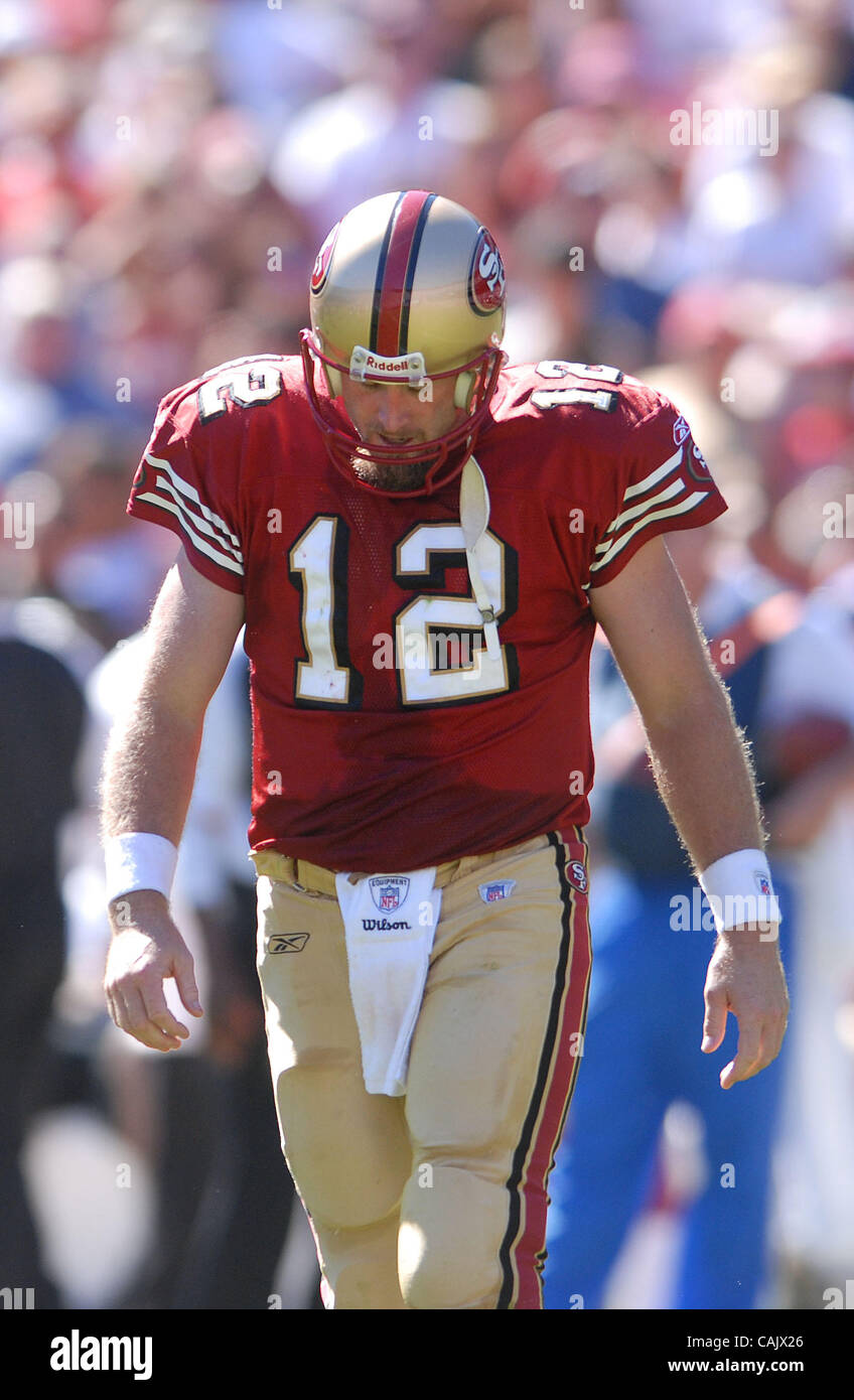 49ers quarterback Trent Dilfer walks back to the huddle after being ...