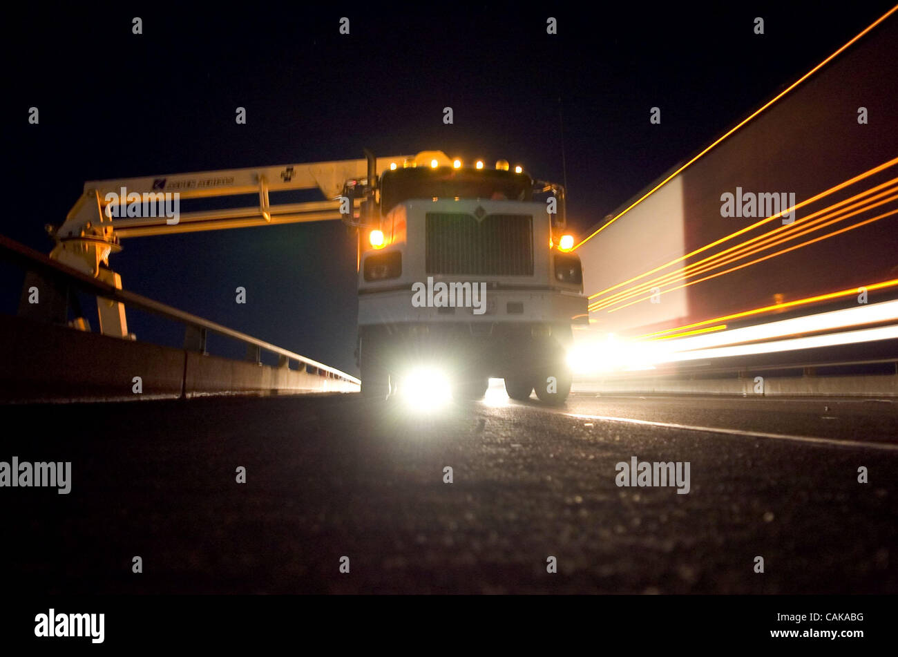 Late night freeway traffic swarms a Cal Trans under bridge inspection ...