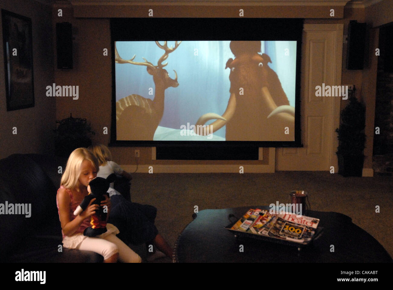 Sitting on their couch, Kelly Jacobsen (cq, left), 7, and her sister ...