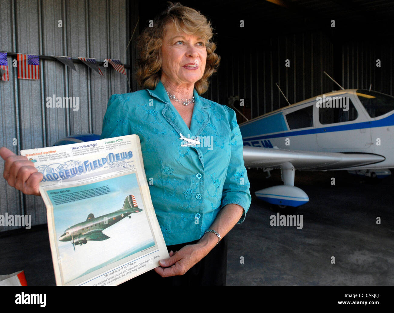 Pilot and instructor Candace Harding holds a photograph of a DC-3 that ...
