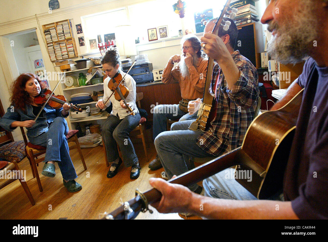 Suzy Thompson (left) plays fiddle during a jam session with friends ...