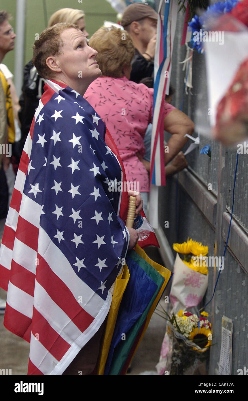 Barbara Dietz of Germany draped in an American flag looks through the ...