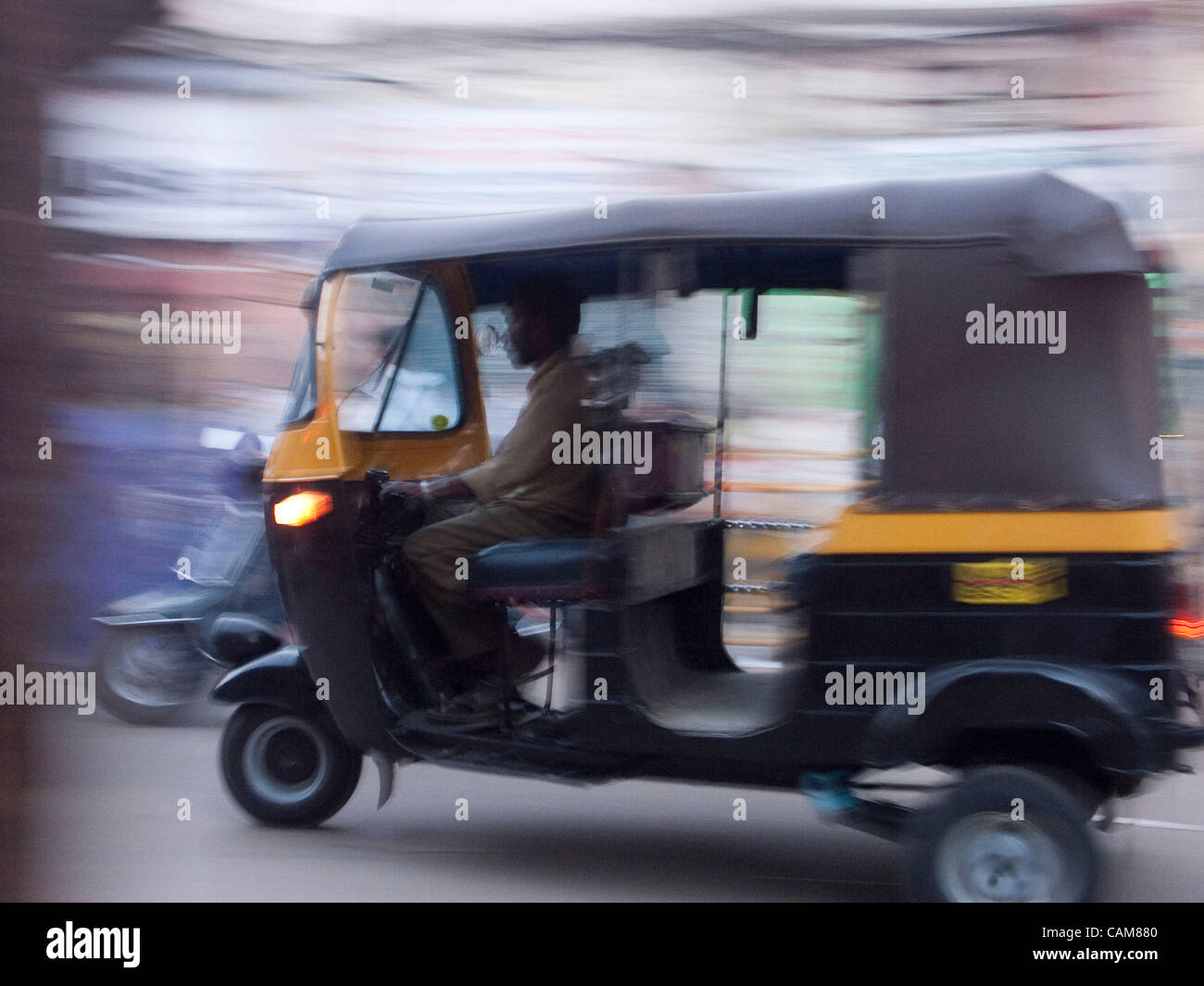 Three wheeled motorized autorickshaws taxis at work in Bangalore India ...
