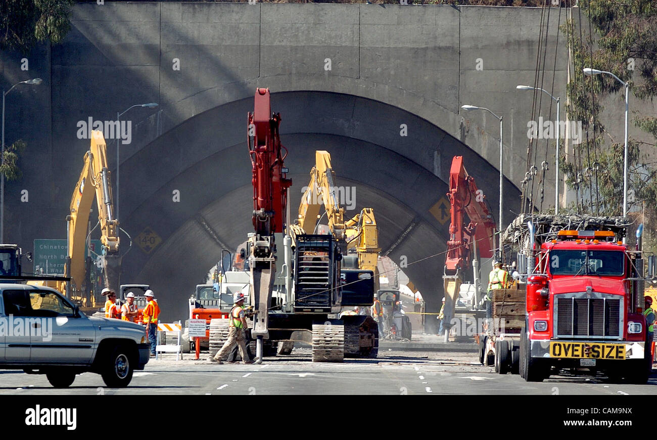 Construction workers for CC Myers Inc. demolish a section of the Bay ...