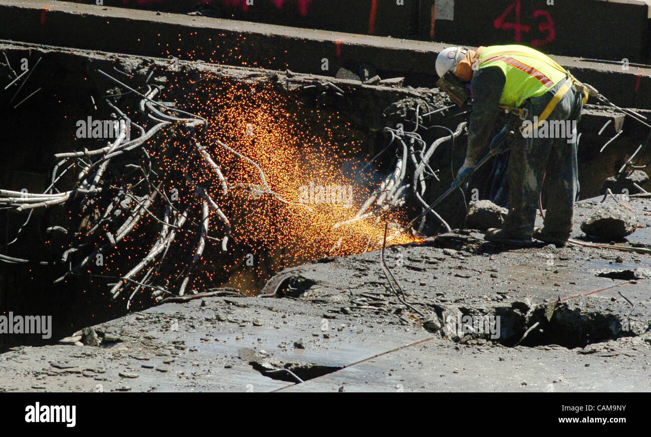 Construction workers for CC Myers Inc. demolish a section of the Bay ...