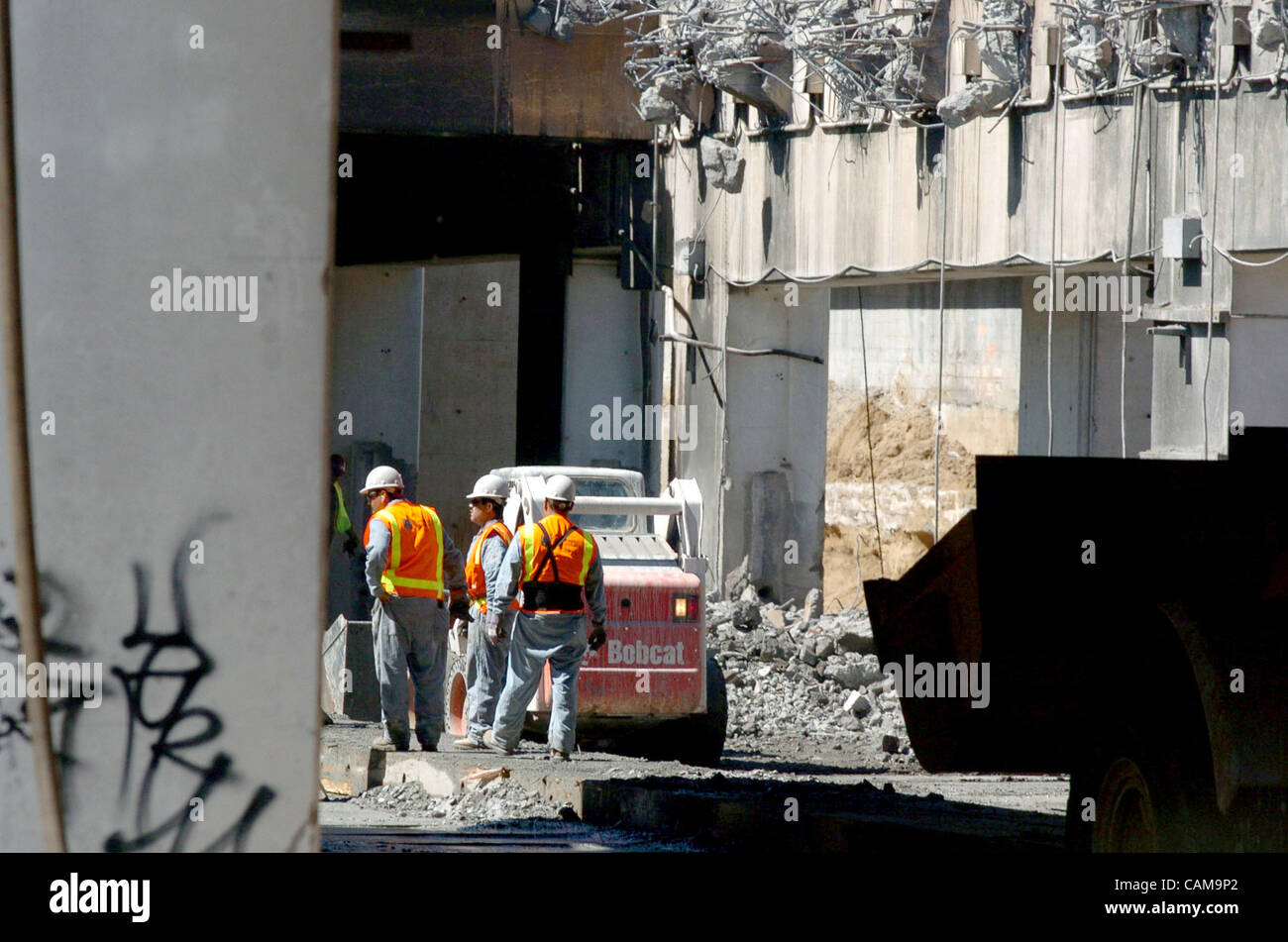 Construction workers for CC Myers Inc. demolish a section of the Bay ...