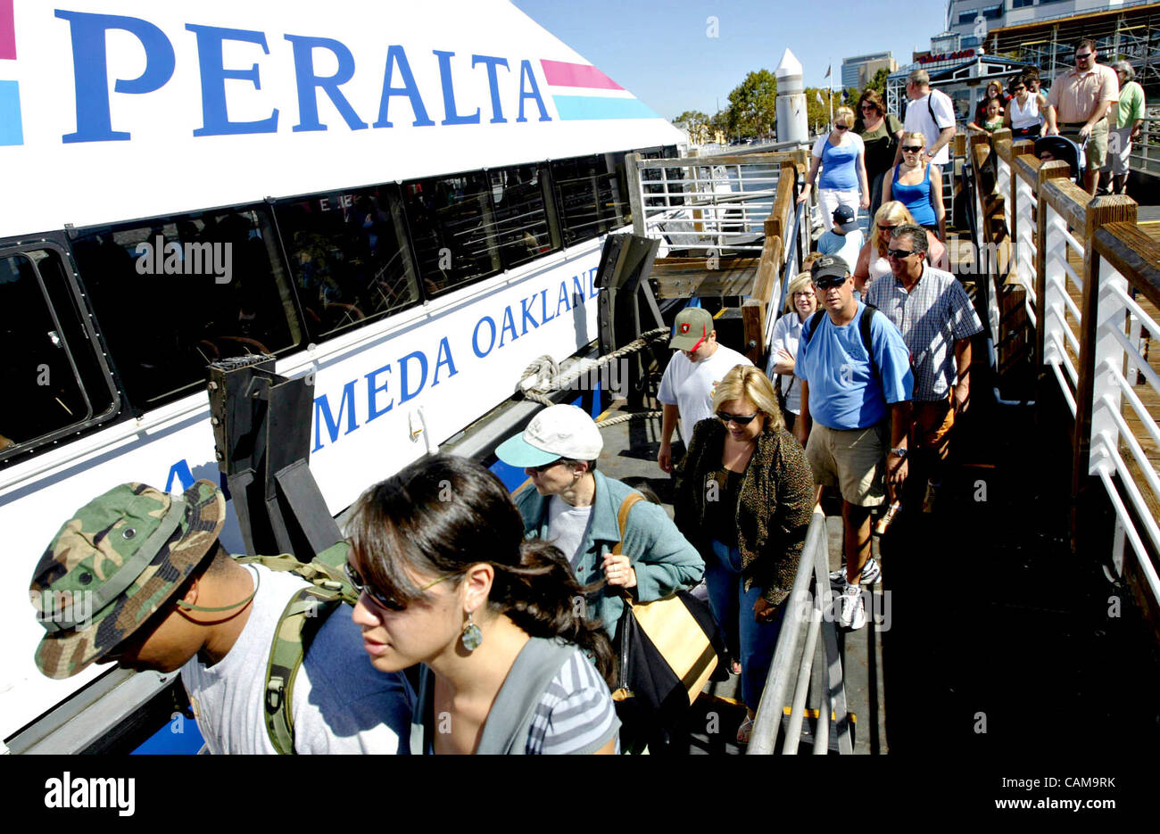 Passengers board the 11:00am ferry to San Francisco at the dock in Jack ...